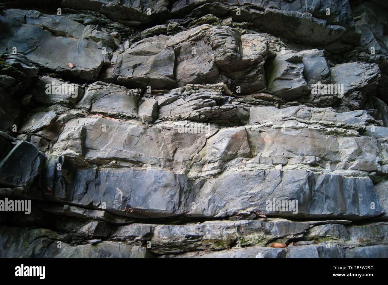 Layers of rock, dark natural stone. Mountain ridge. Wall. Geology ...