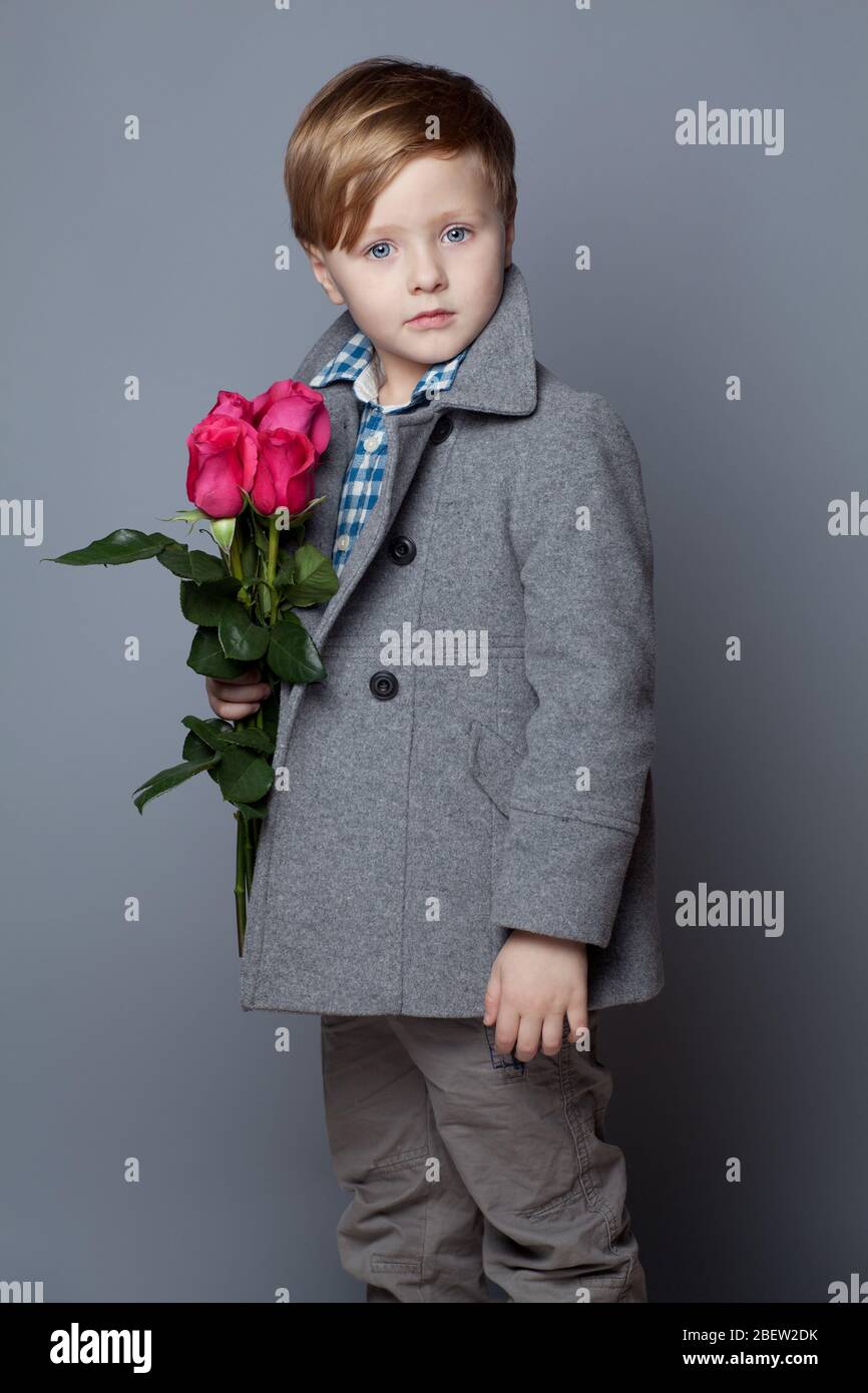 Boy holding flowers behind his back hi-res stock photography and images ...