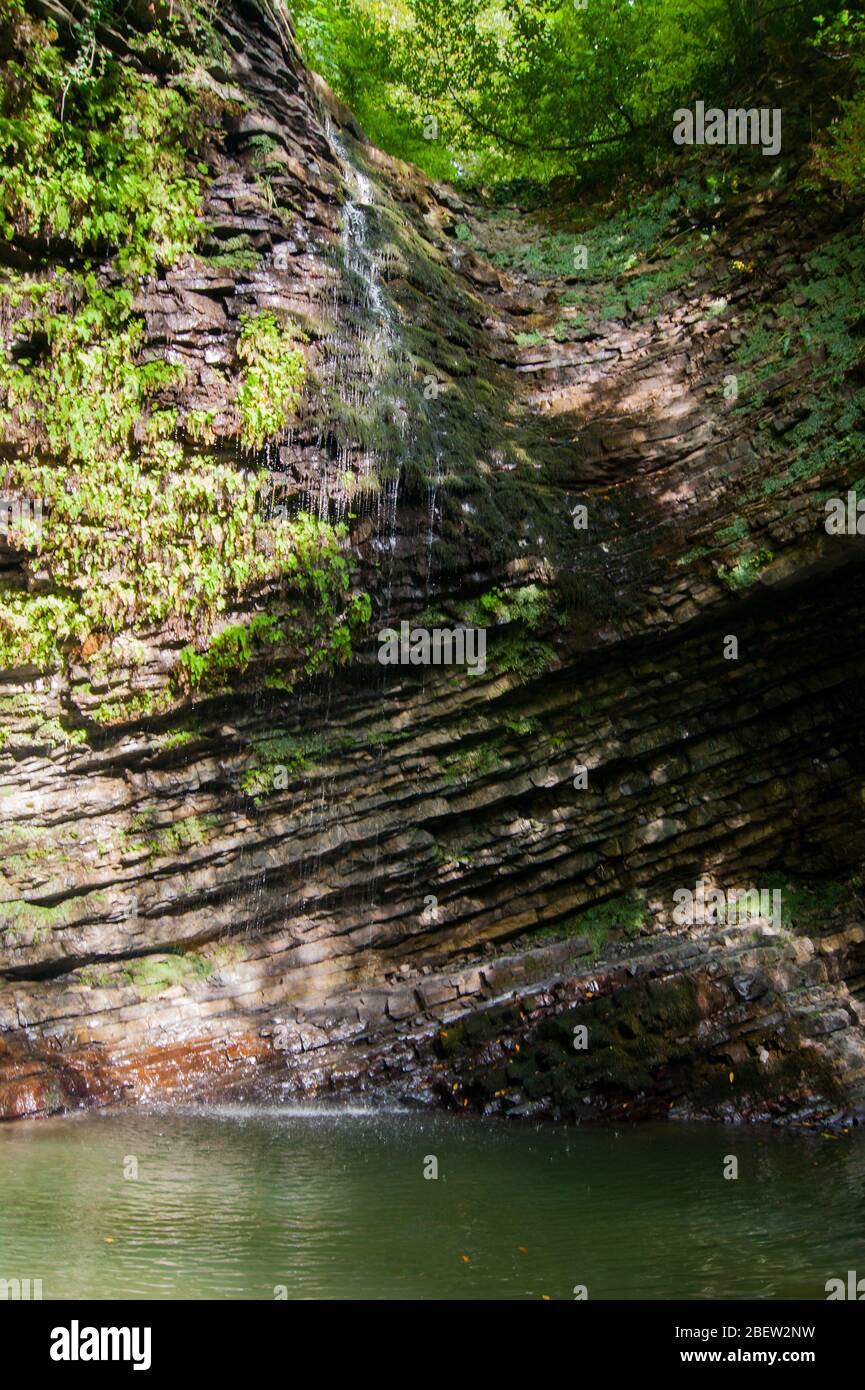 A small mountain waterfall with very clean ice water. Gorge. Rock ...