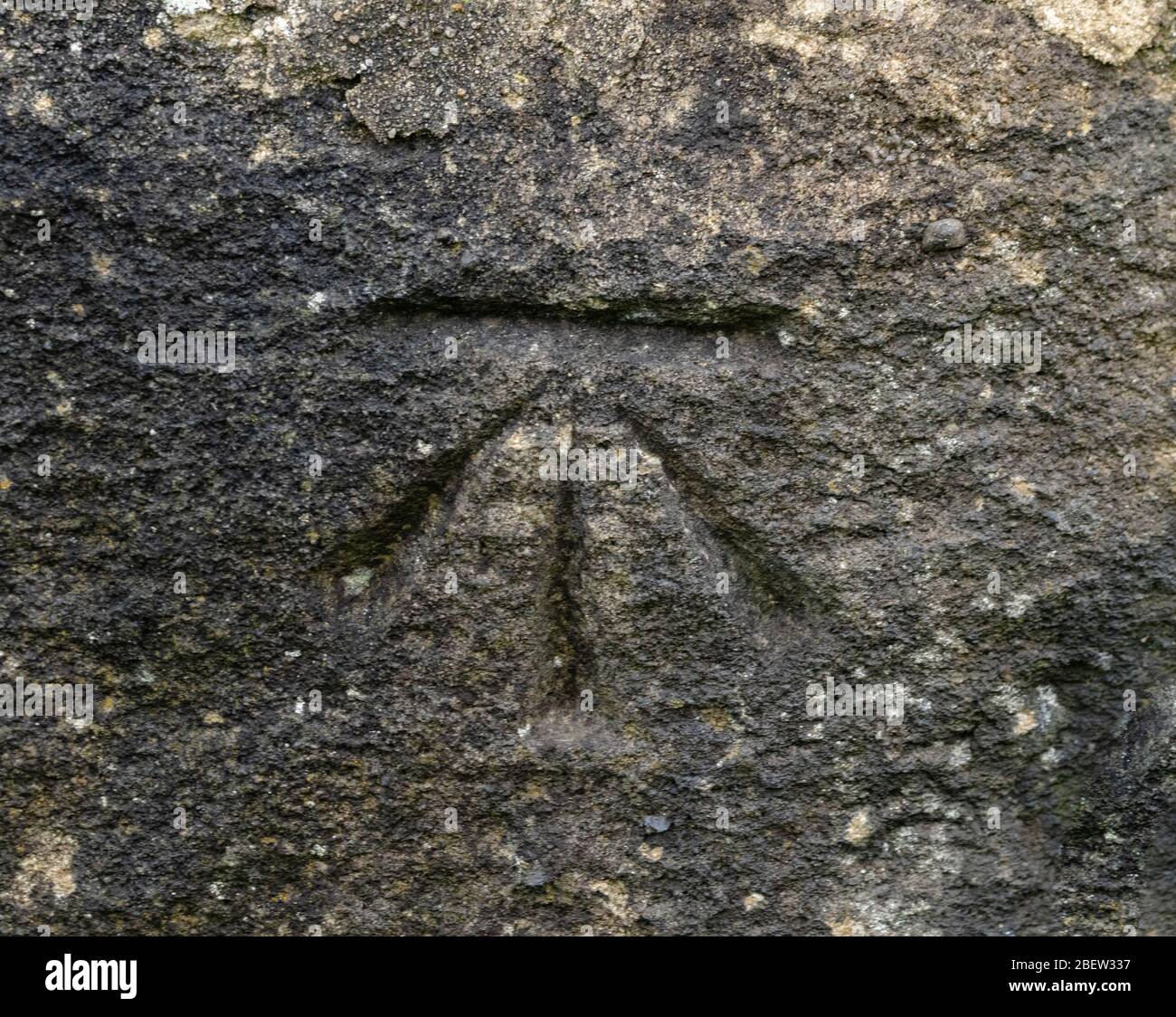 A cut benchmark on a stone wall in Baildon, Yorkshire, England, UK ...