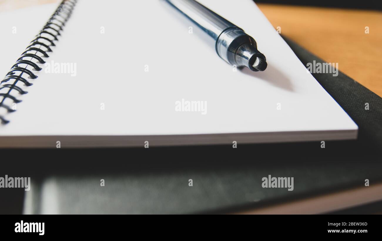 front view of black marker and school notebook, felt-tip pen and spiral ...