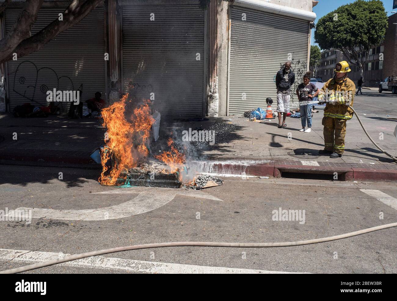 Los Angeles, California, USA. 15th Apr, 2020. A firefighter puts out a ...