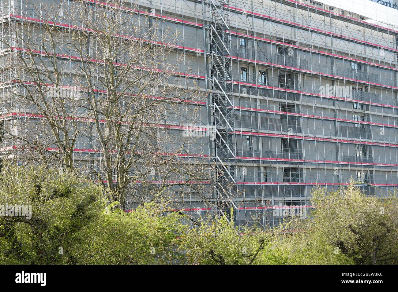 High apartment house in construction, rough building covered by ...