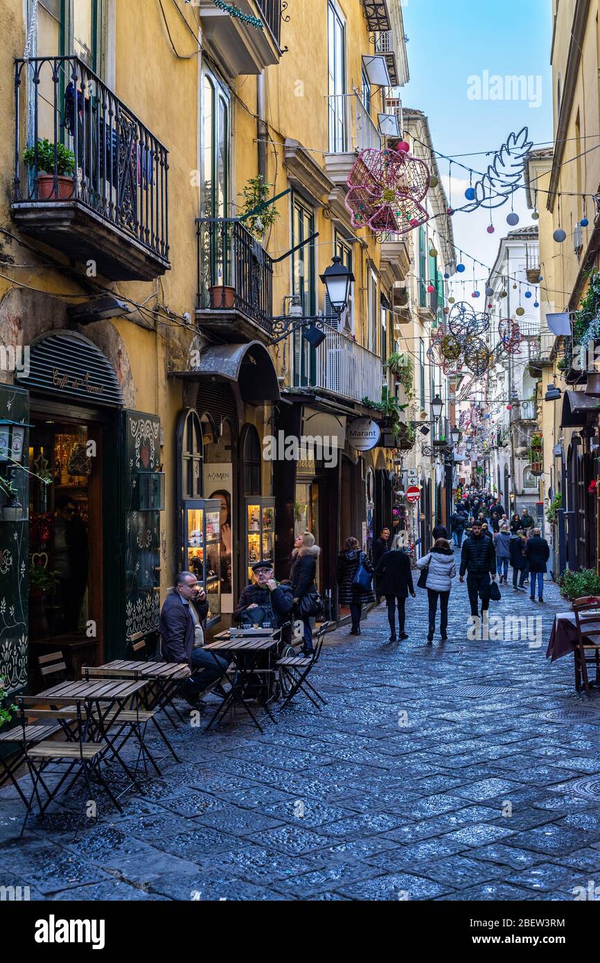 People strolling in a typical street of Salerno old town during ...