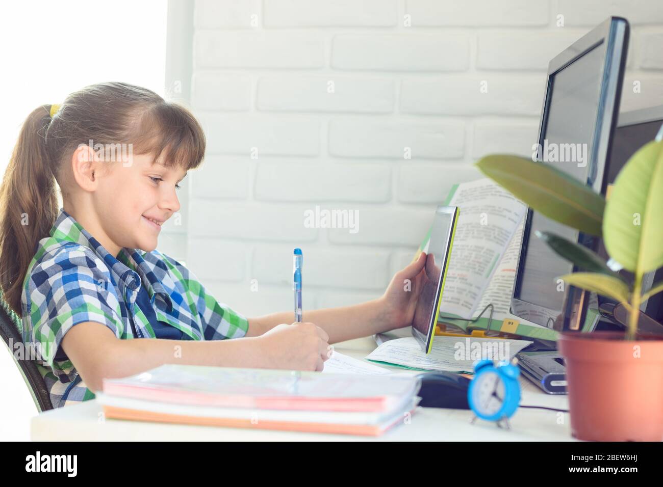 Happy girl watching entertaining online video tutorial Stock Photo - Alamy