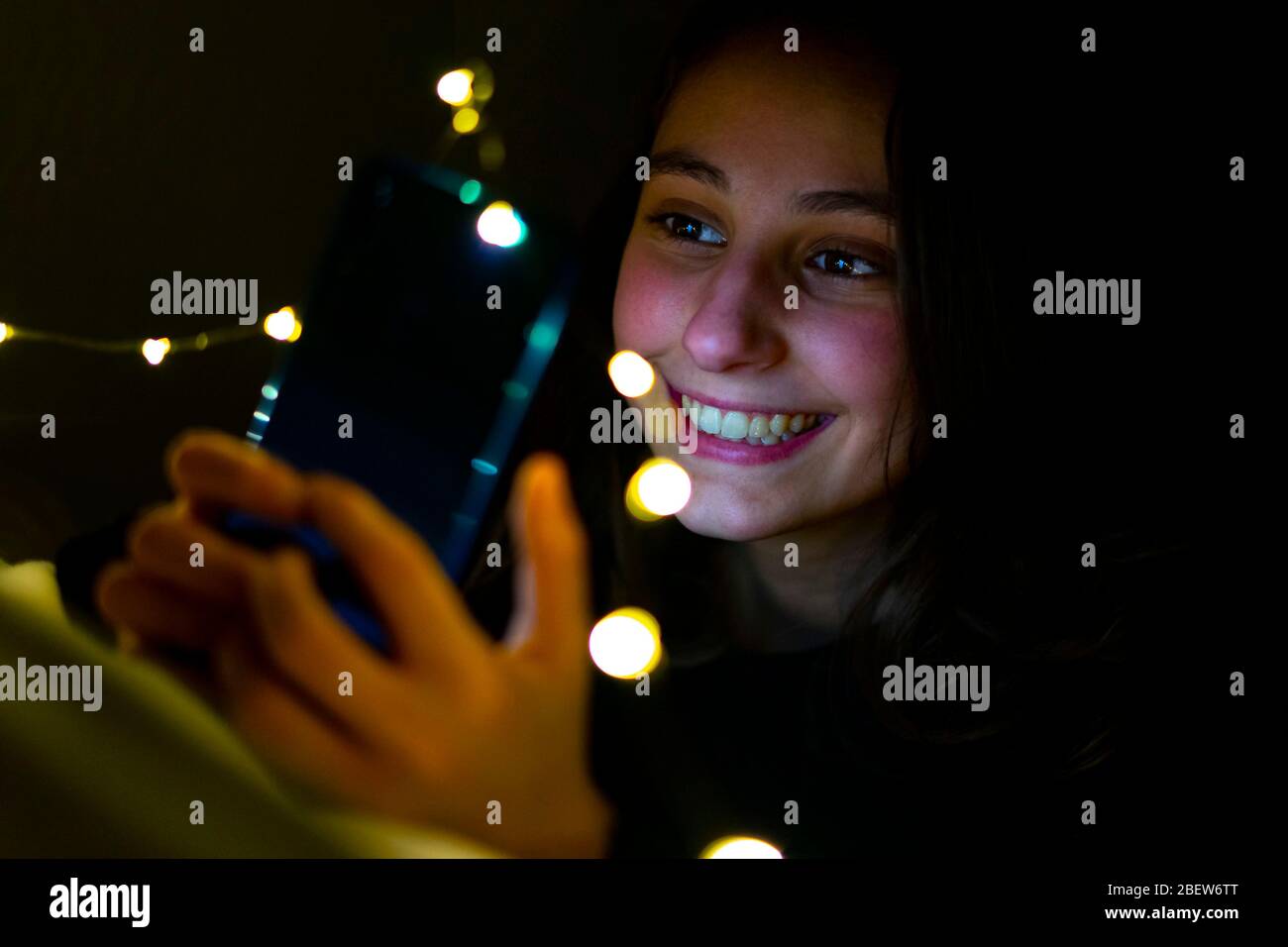 Woman using the phone at night in bed Stock Photo - Alamy