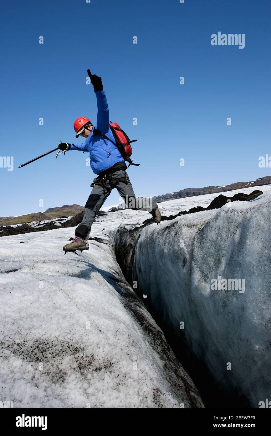 Man jumping over crevasse hi-res stock photography and images - Alamy