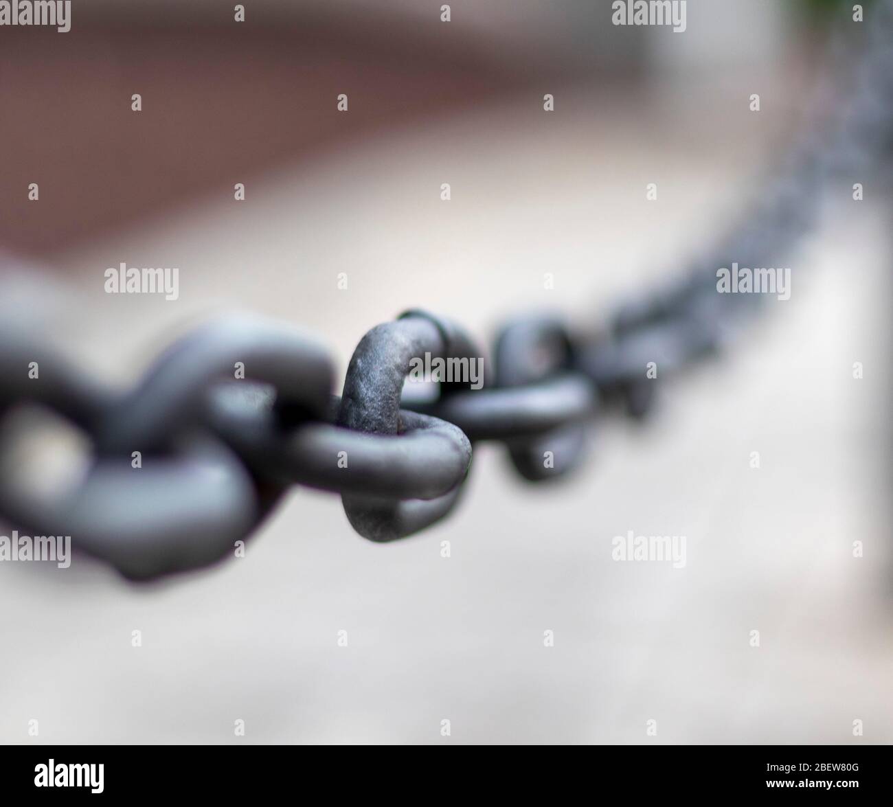 Long faded black street chain Stock Photo - Alamy