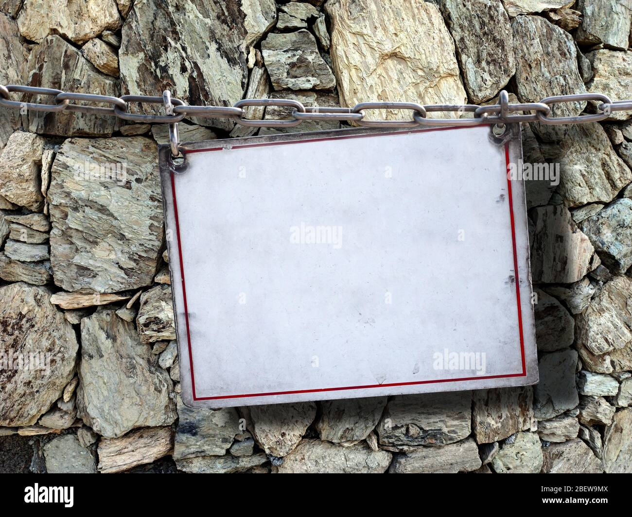 Natural stone wall with metal shield, hung on a chain, copy room ...