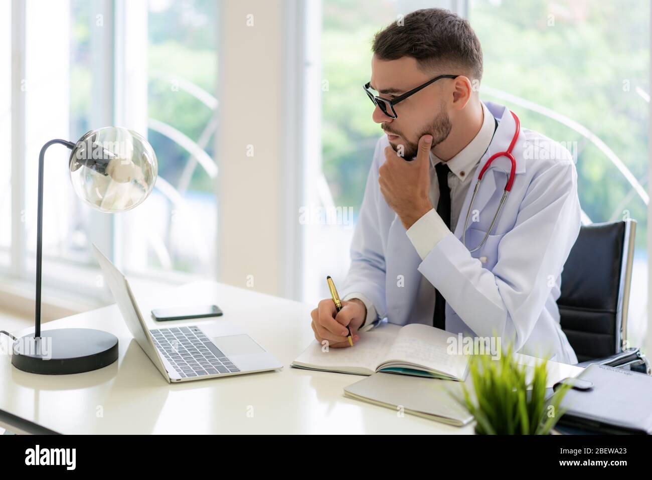 Man doctor is thinking about the result of an examination of his ...