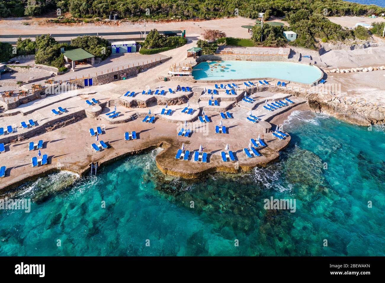 Aerial view of Ploce beach with swimming pool and stormy waves on the ...