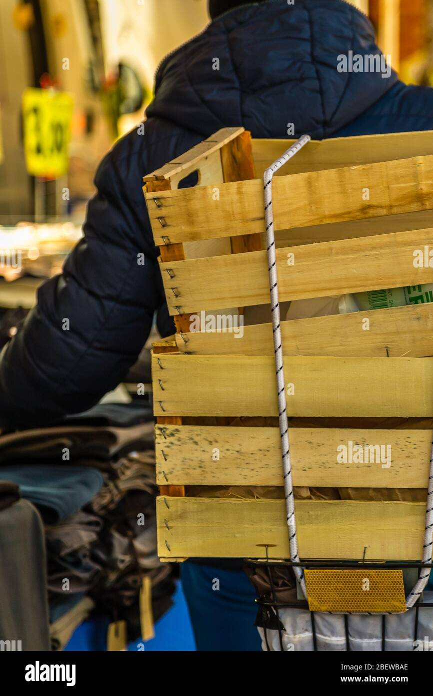 wooden boxes carried by rider in street market Stock Photo - Alamy