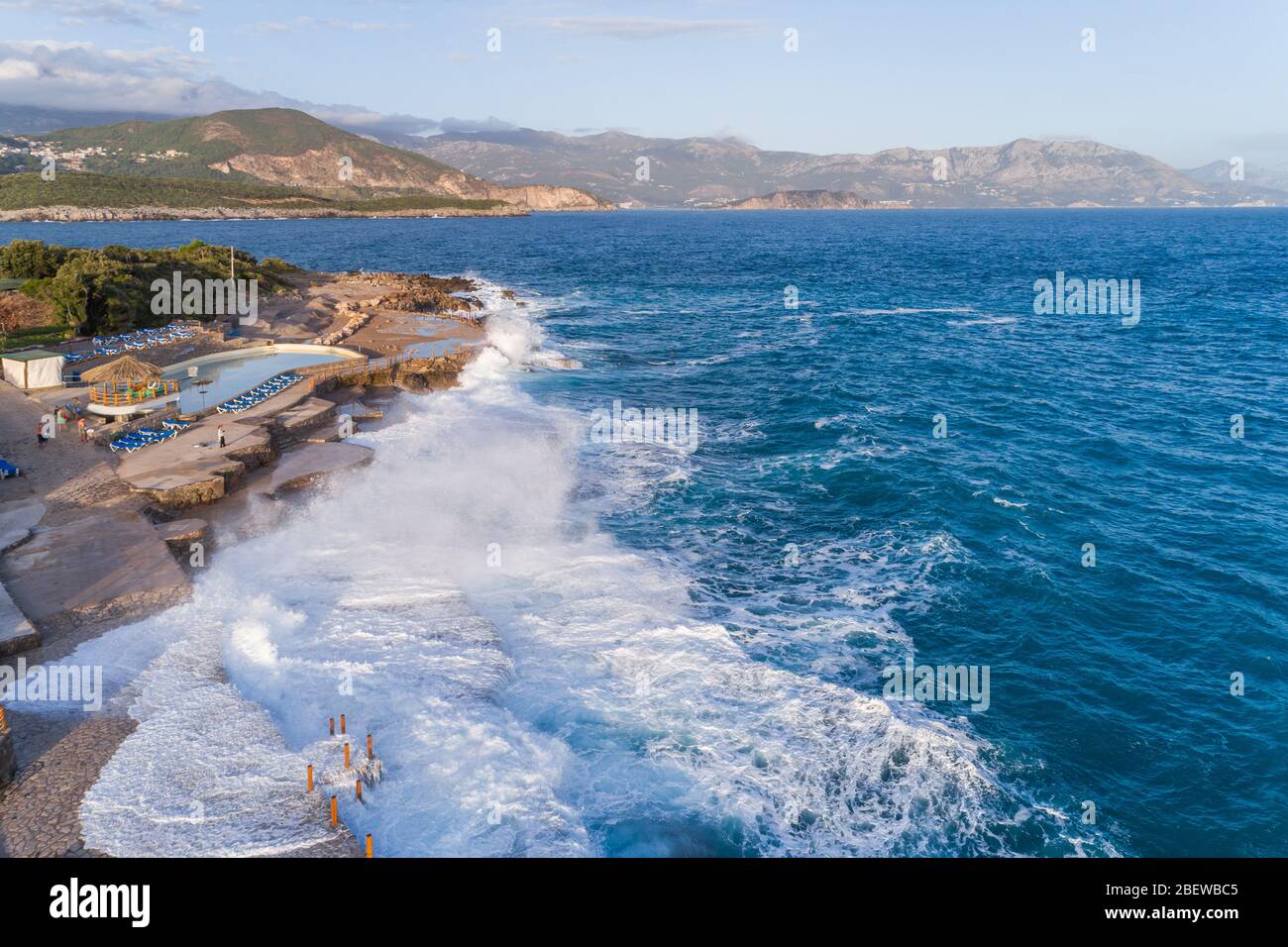 Aerial view of Ploce beach with swimming pool and stormy waves on the ...