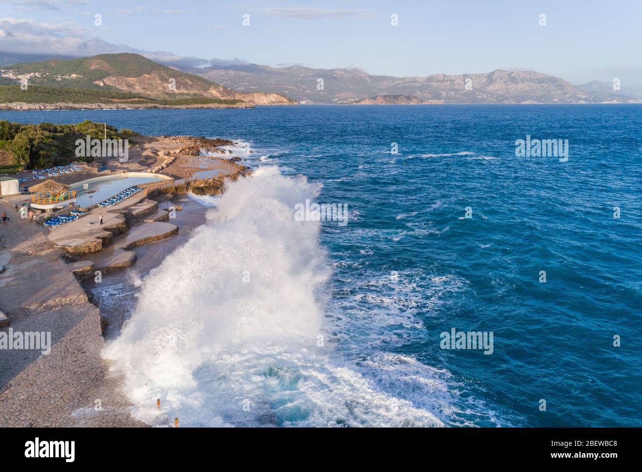 Aerial view of Ploce beach with swimming pool and stormy waves on the ...