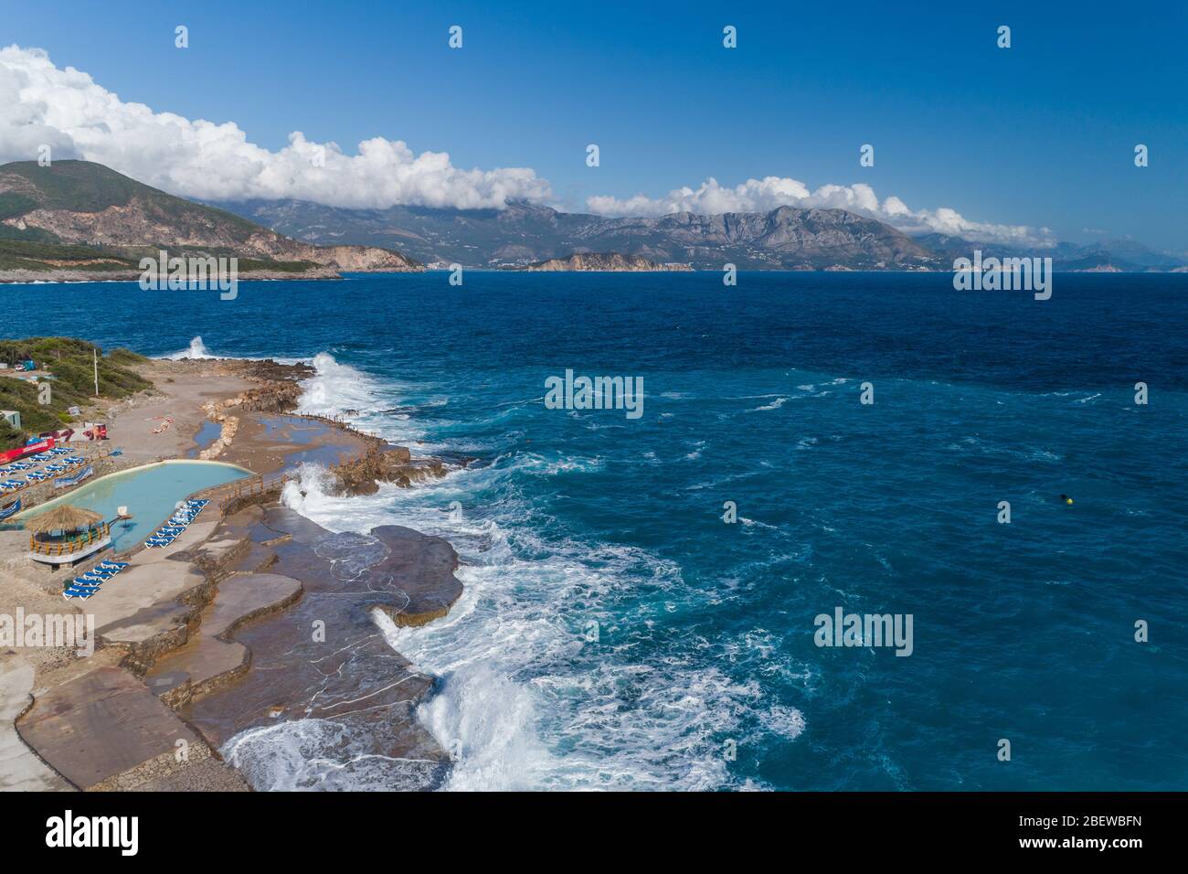 Aerial view of Ploce beach with swimming pool and stormy waves on the ...