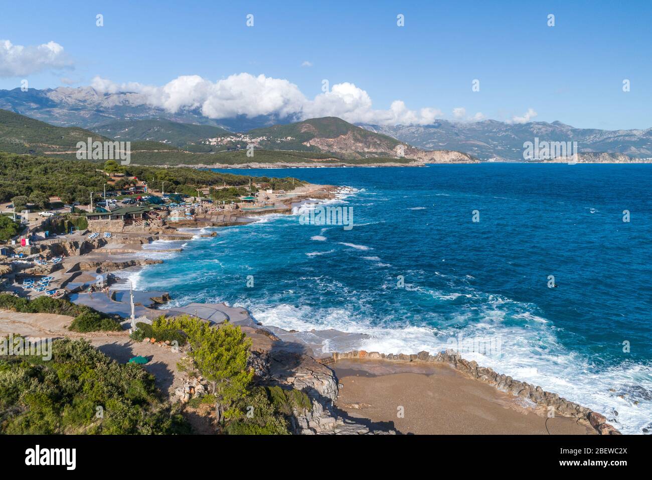 Aerial view of Ploce beach with swimming pool and stormy waves on the ...