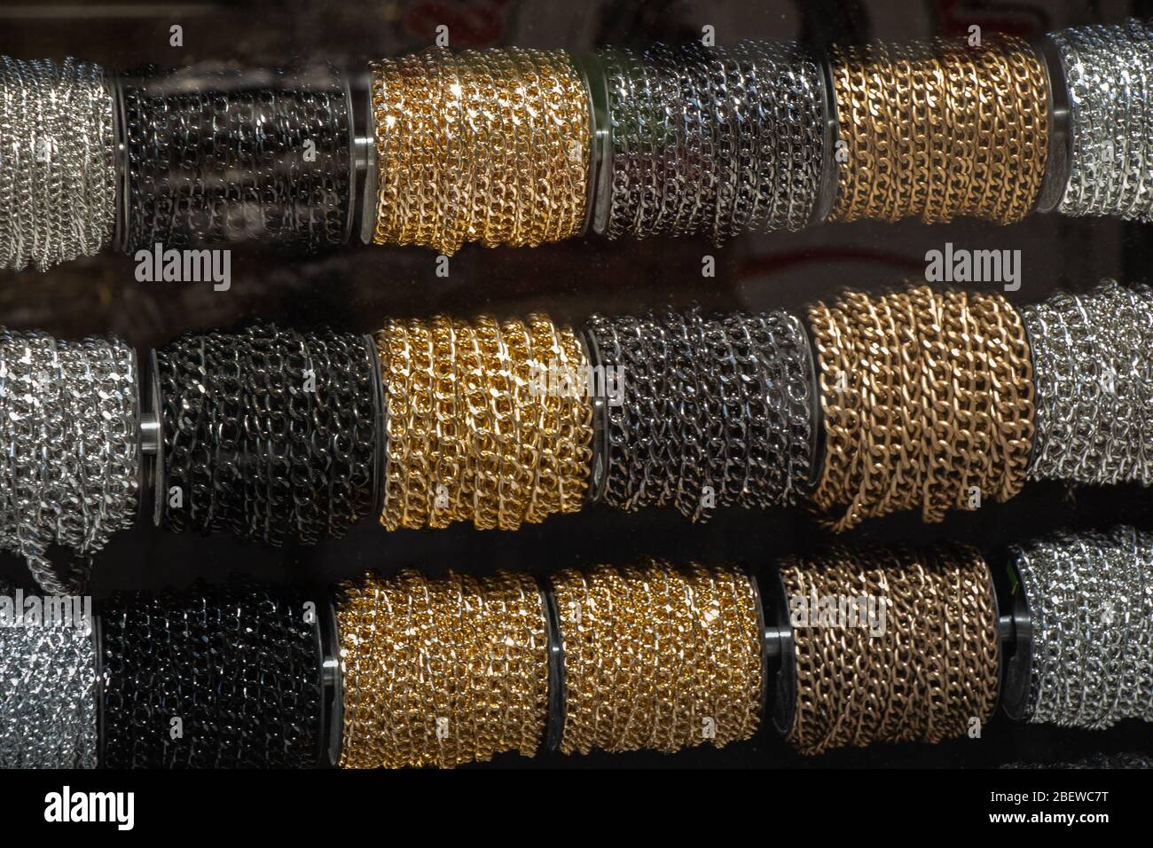 Rolls of metal chains as a background texture Stock Photo - Alamy