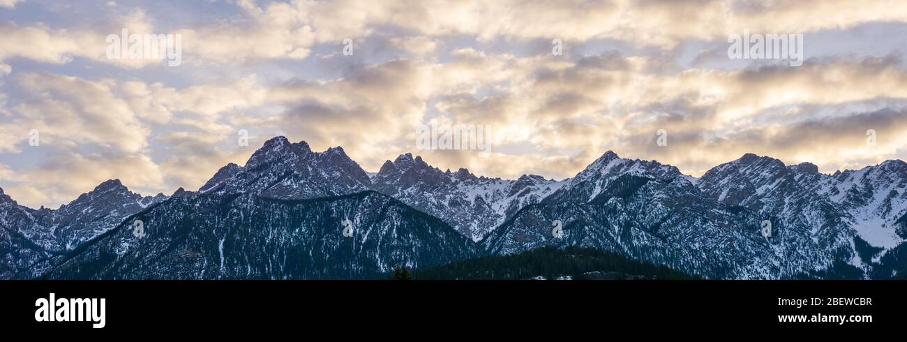 close-up view of the mountain peak with trees and snow on it sunset ...
