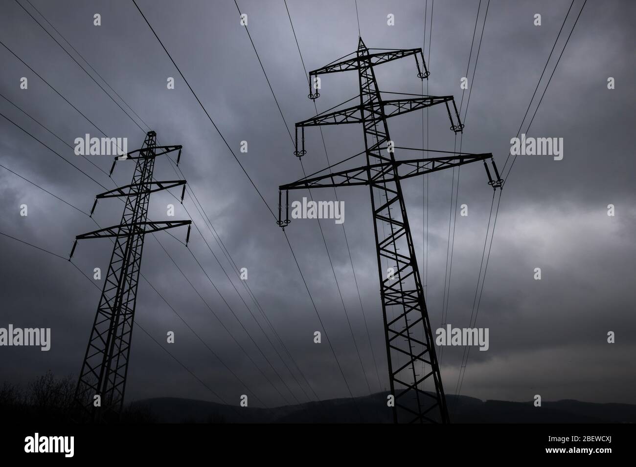 Electricity pylon evening winter storm clouds Stock Photo - Alamy