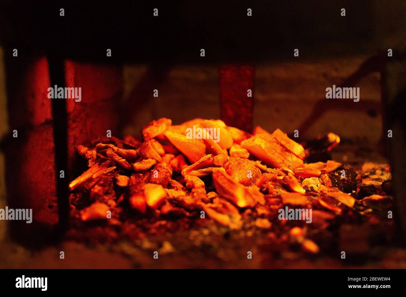 Red hot coals burning ready to be placed under the grill and cooking a ...