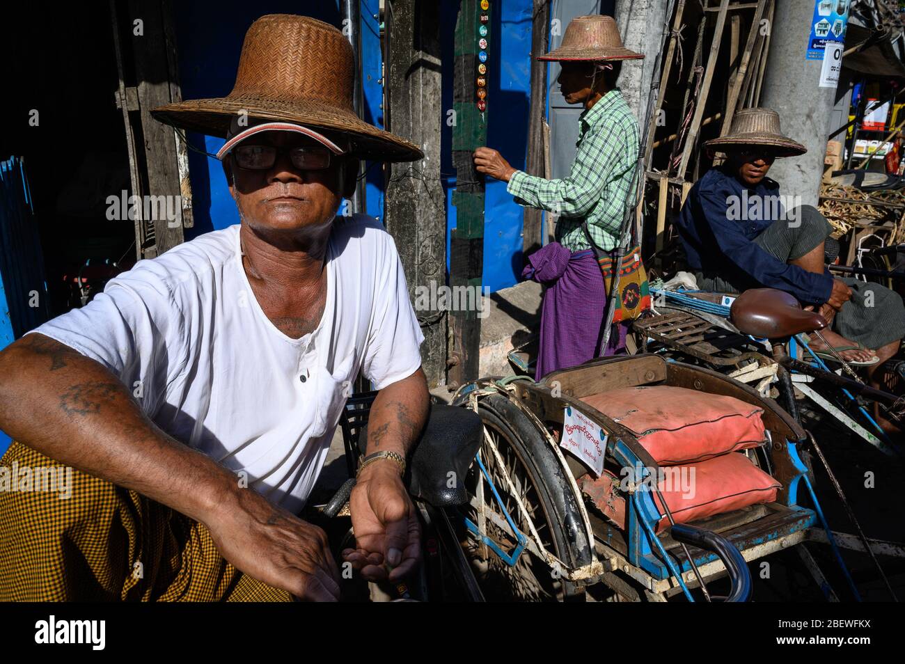 Hatted Burmese men in the midday sun, Pathein, Myanmar Stock Photo - Alamy