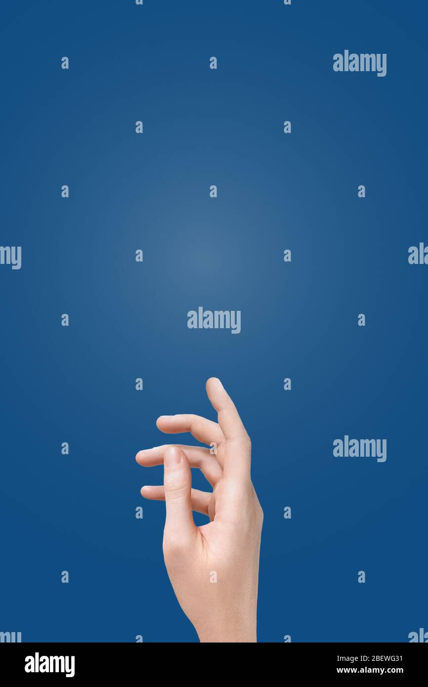 Color year 2020 blue. Female hand raised up on a blue background ...