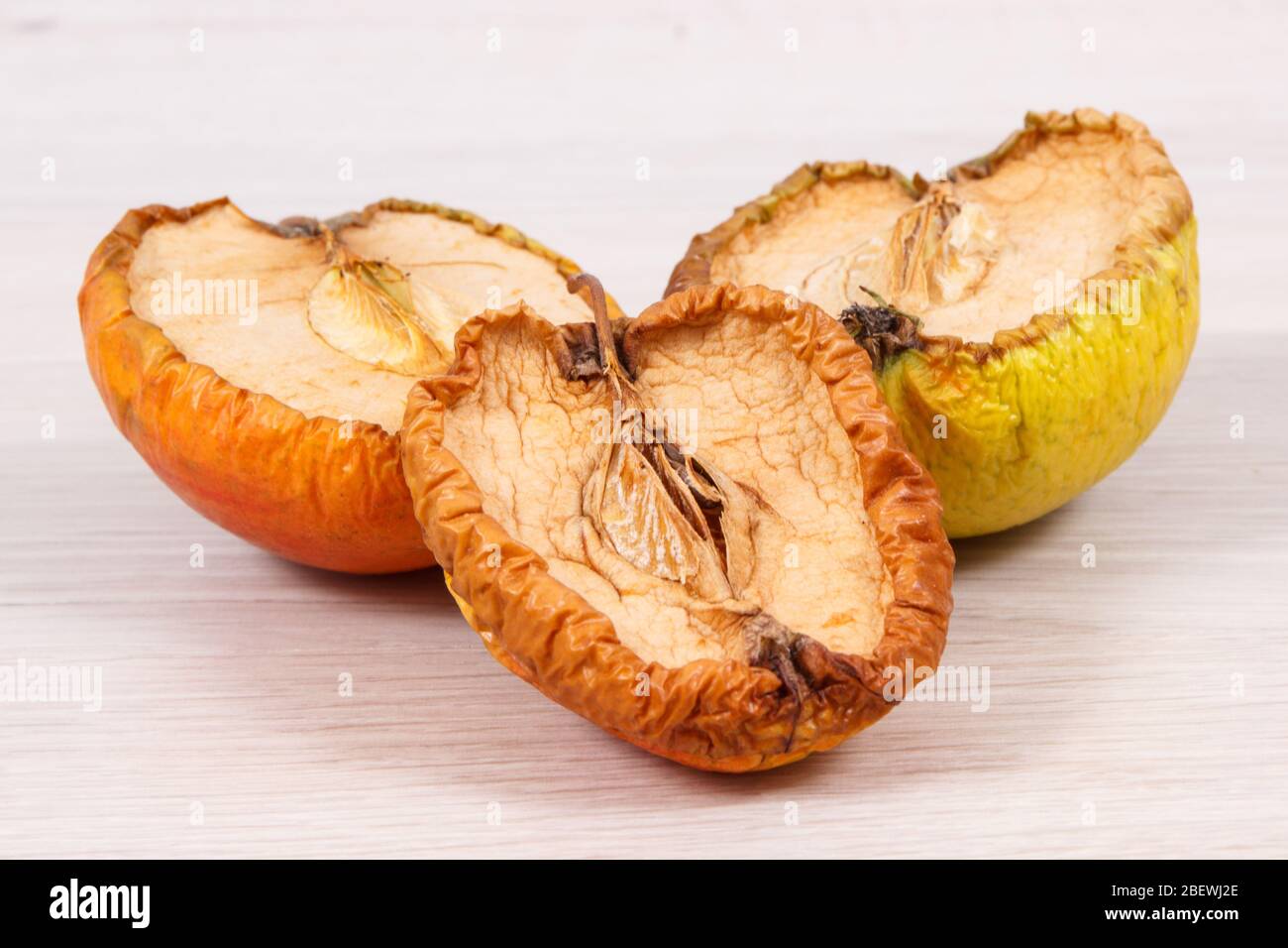 Old wrinkled moldy apple on board, unhealthy and disgusting eating ...