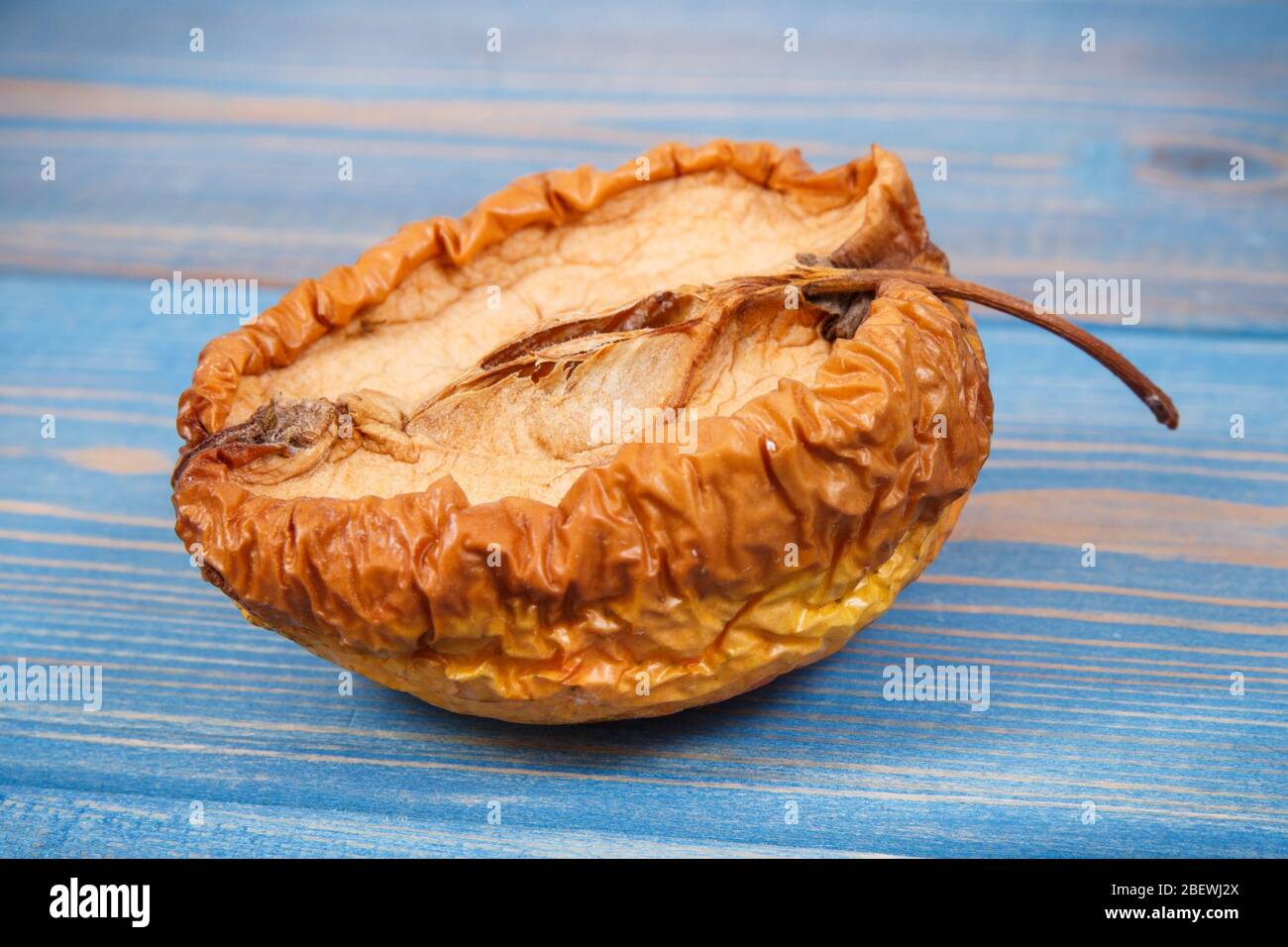 Old wrinkled moldy apple on board, concept of unhealthy and disgusting ...