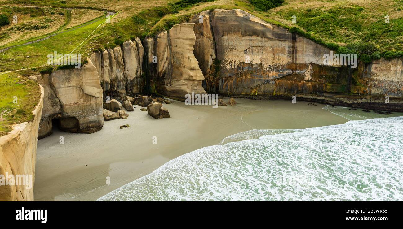 Tunnel Beach surrounded by into the sandstone cliffs near Dunedin New ...