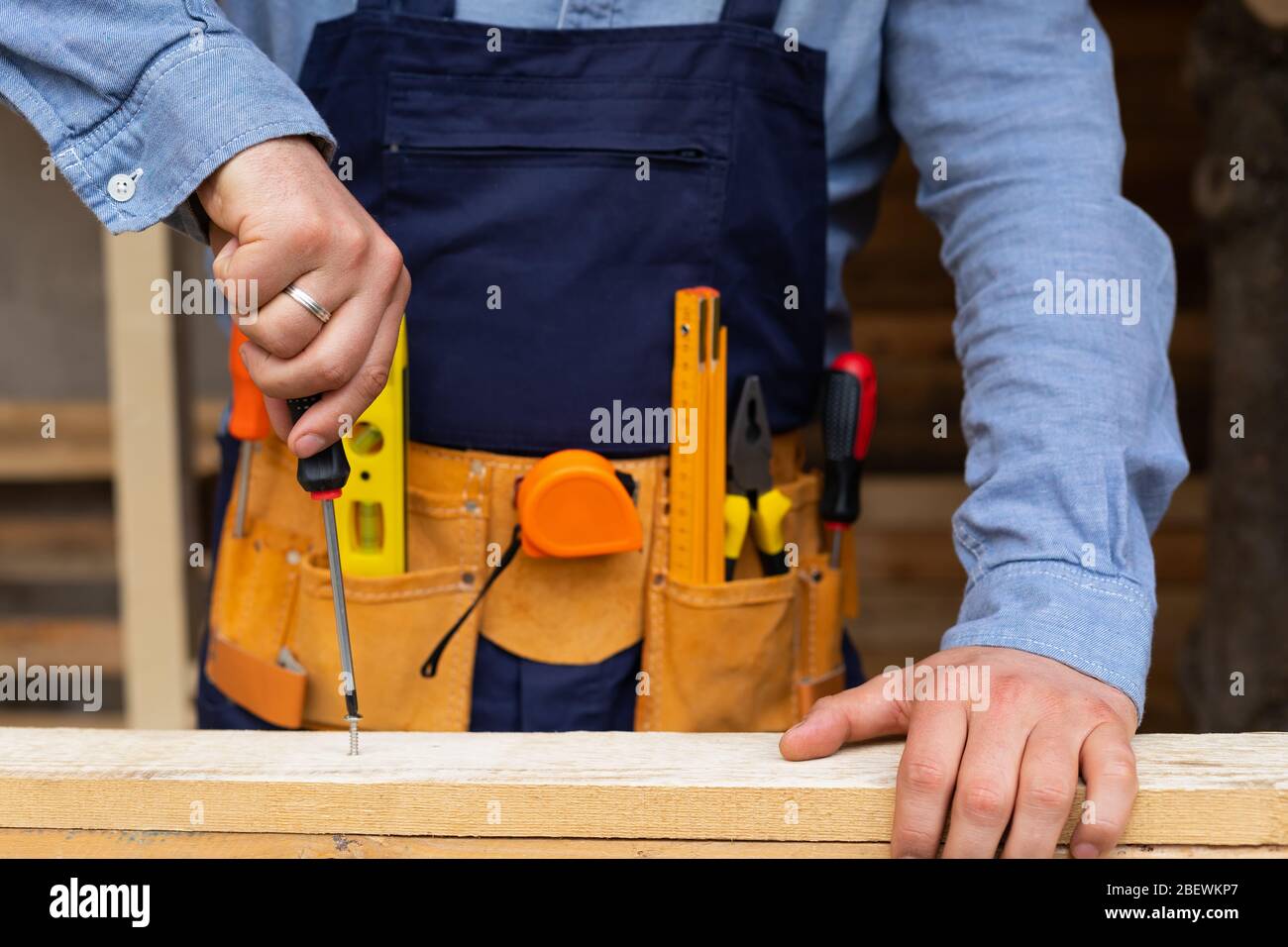 Close up picture of carpenters hands measuring plank - DIY renovation ...