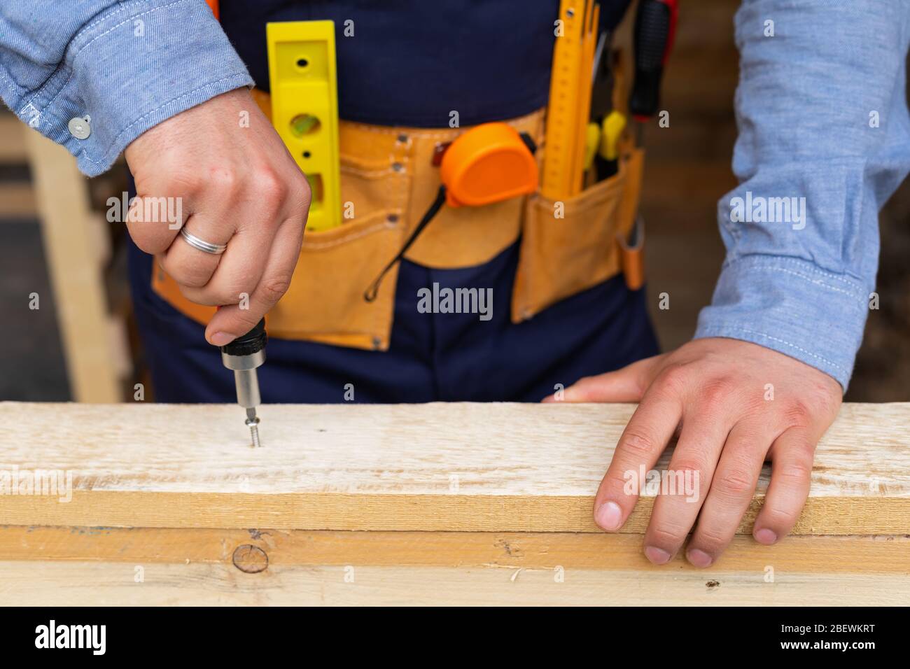 Close up picture of carpenters hands measuring plank - DIY renovation ...