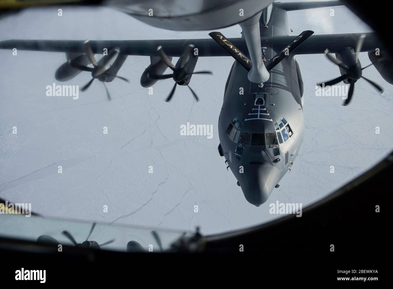 A U.S. Air Force C-130 Hercules approaches a KC-135 Stratotanker boom ...