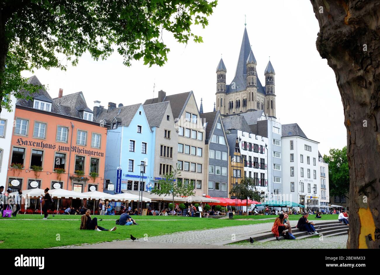 People gathering relaxing in the waterfront of River Rhine with old ...