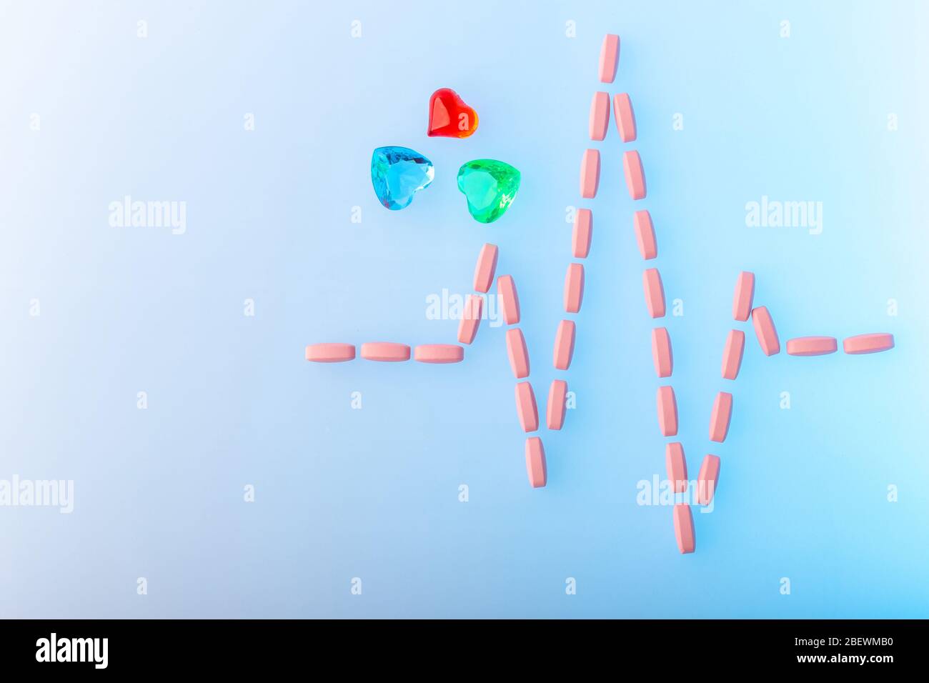 Pills in shape of cardiogram pulse on blue gradient background ...