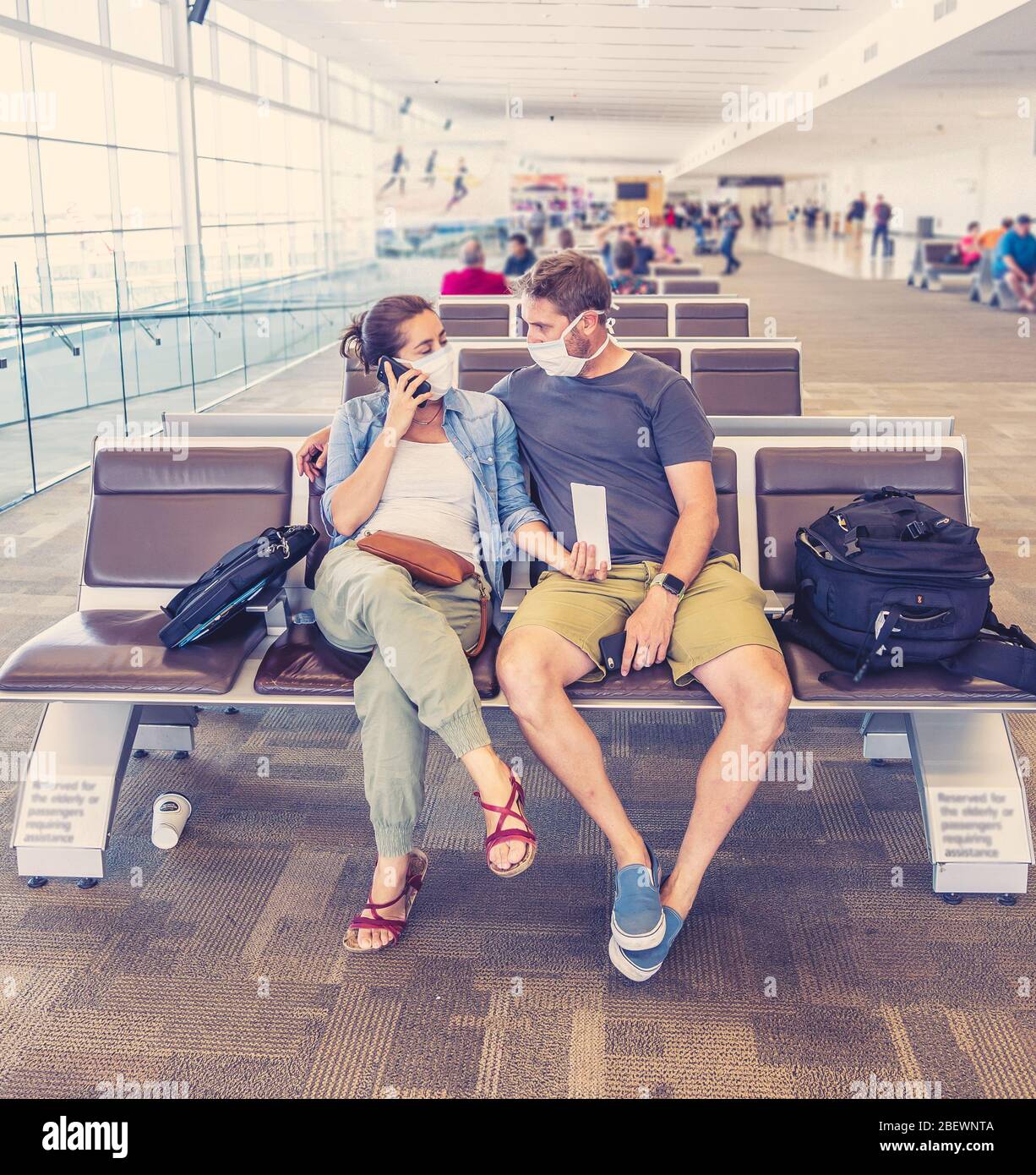 COVID-19 worldwide borders closures. Couple with face mask stuck in ...