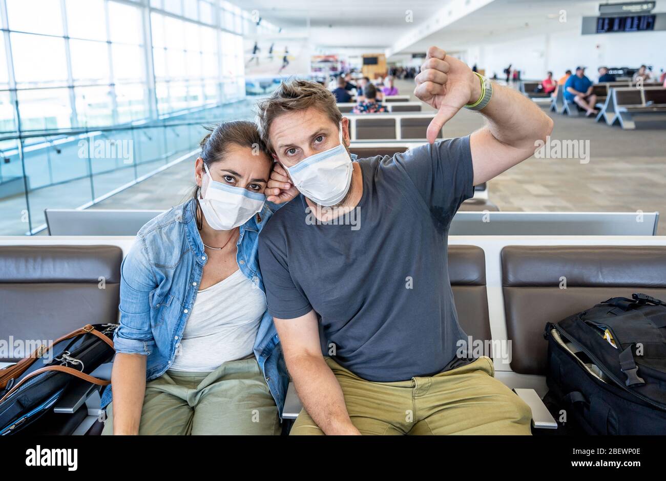 COVID-19 worldwide borders closures. Couple with face mask stuck in ...