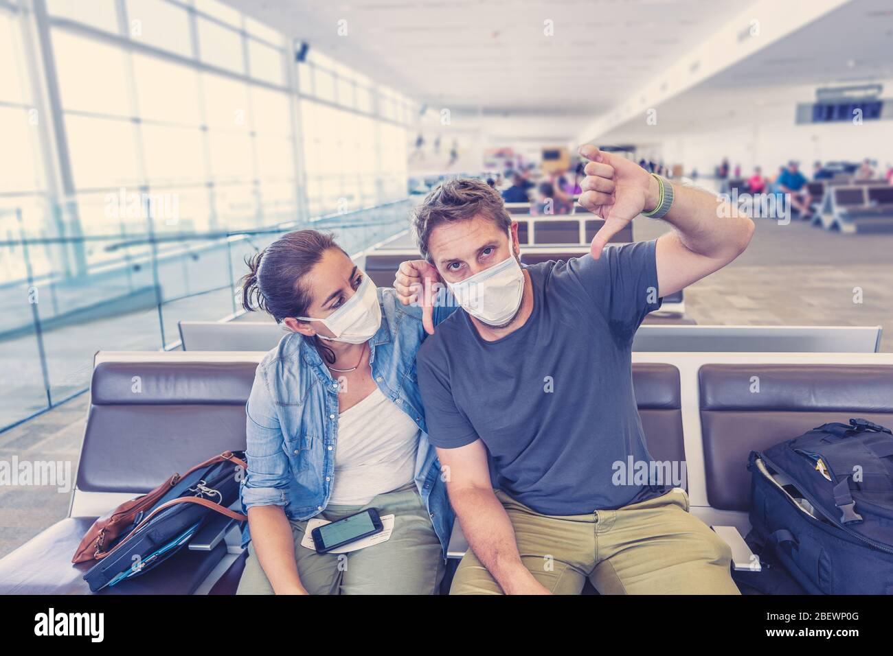 COVID-19 worldwide borders closures. Couple with face mask stuck in ...