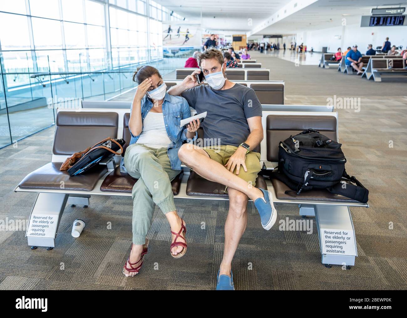 COVID-19 worldwide borders closures. Couple with face mask stuck in ...