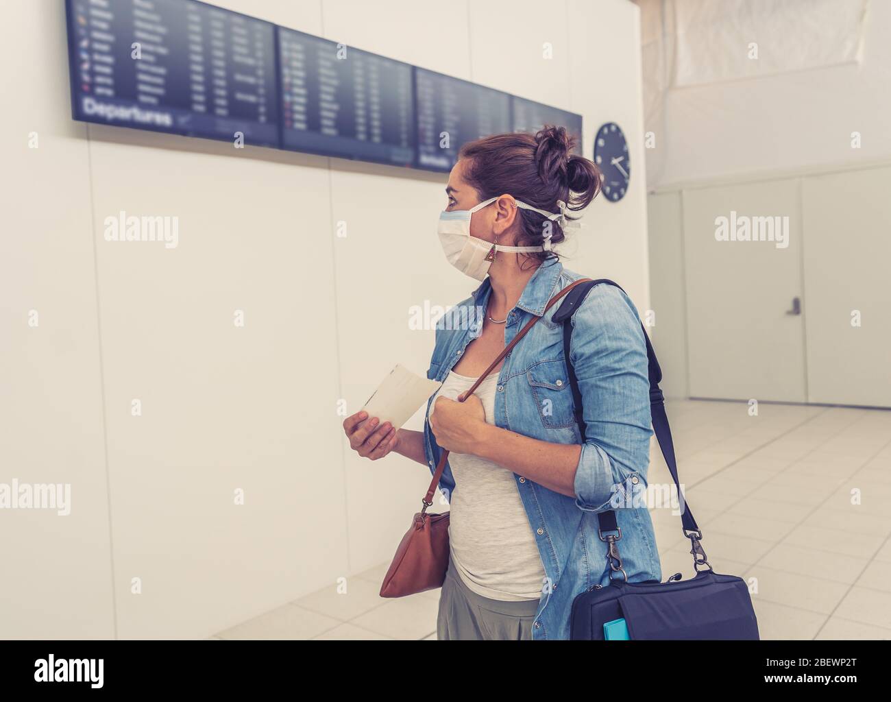 COVID-19 worldwide borders closures.Traveler with face mask stuck in ...