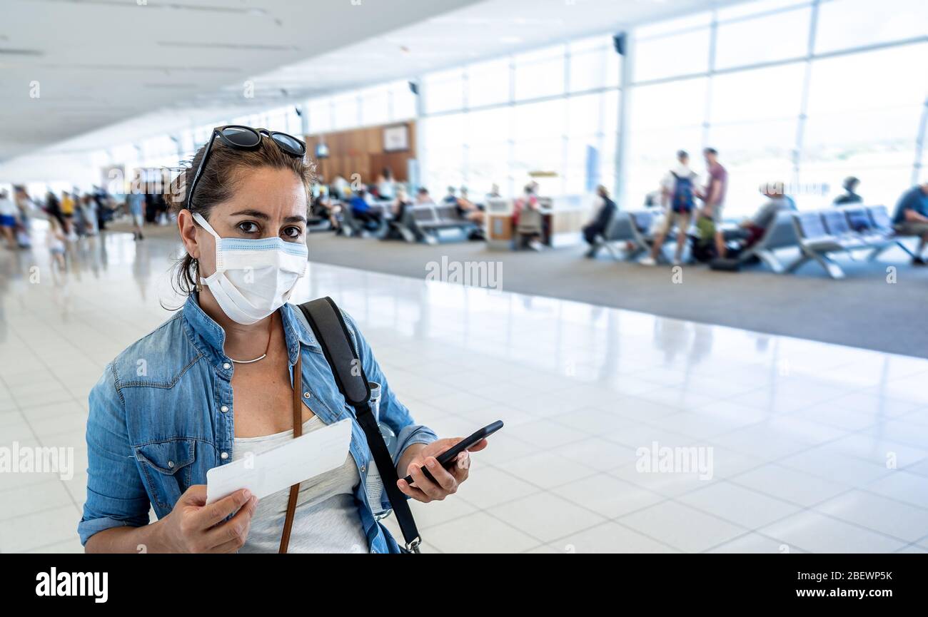 COVID-19 worldwide borders closures.Traveler with face mask stuck in ...