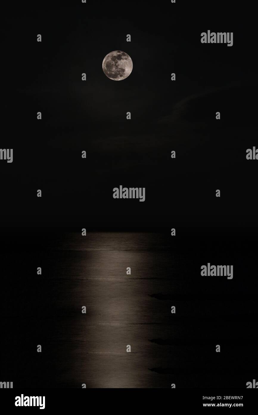 Moon and its path on seashore Stock Photo - Alamy