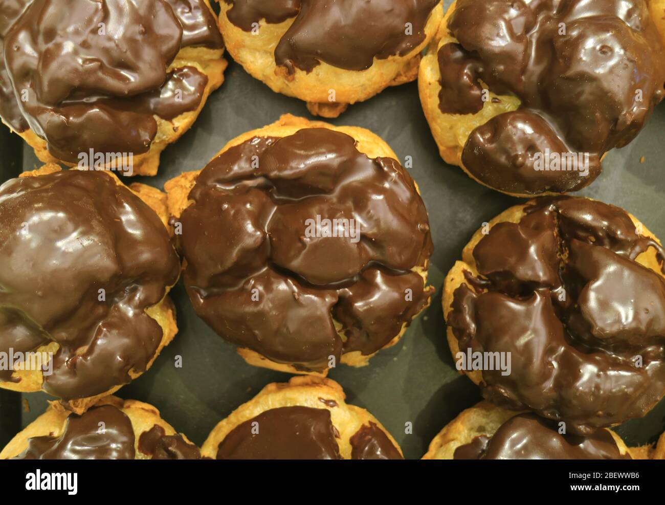Top View of a Tray of French Choux Pastries with Chocolate Ganache ...