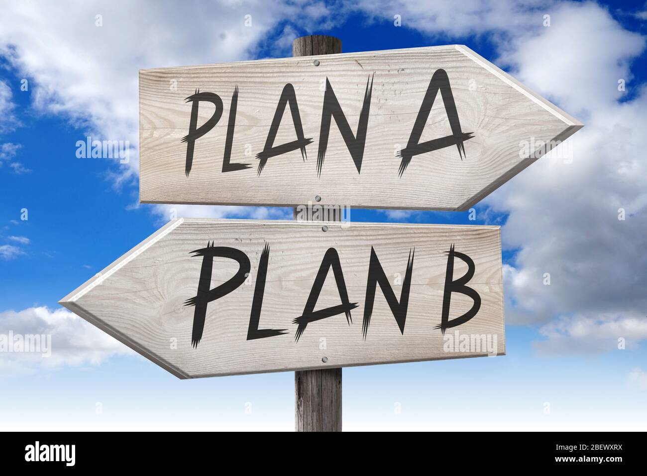 Wooden signpost with two arrows Stock Photo - Alamy