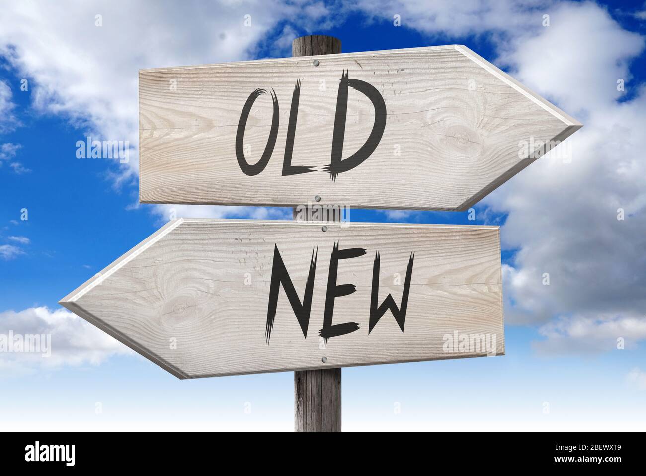 Wooden signpost with two arrows Stock Photo - Alamy