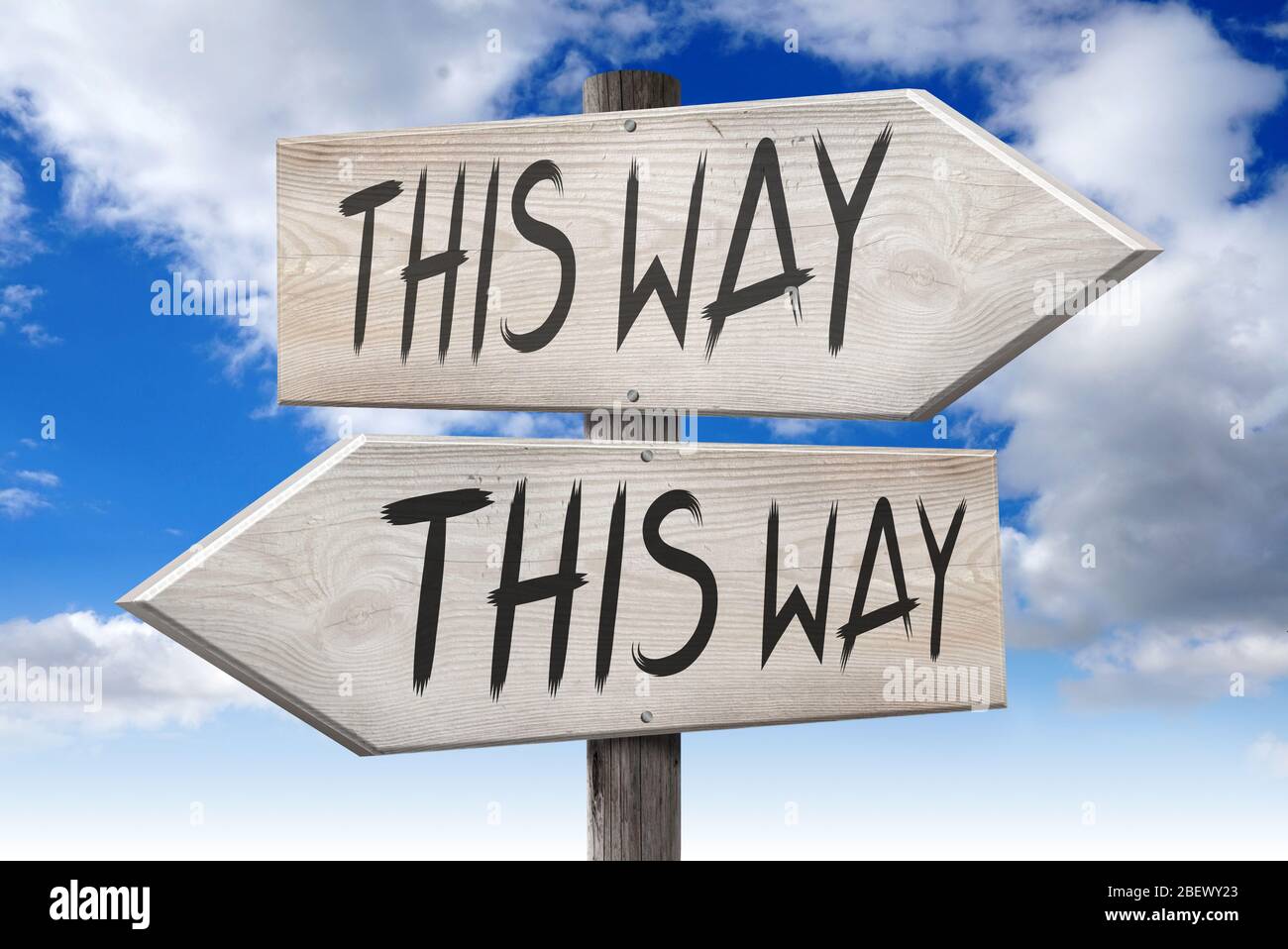 Wooden signpost with two arrows Stock Photo - Alamy