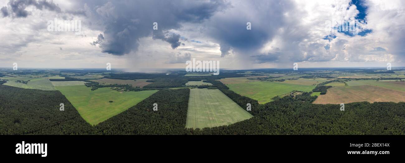 Rain over rural countryside aerial panorama. Rain clouds shot from a ...