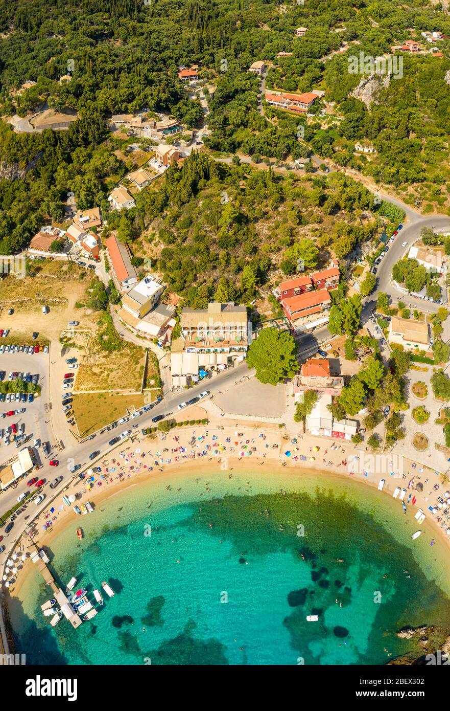Sunny beach in Greece village Paleokastritsa. Busy beach on a ...
