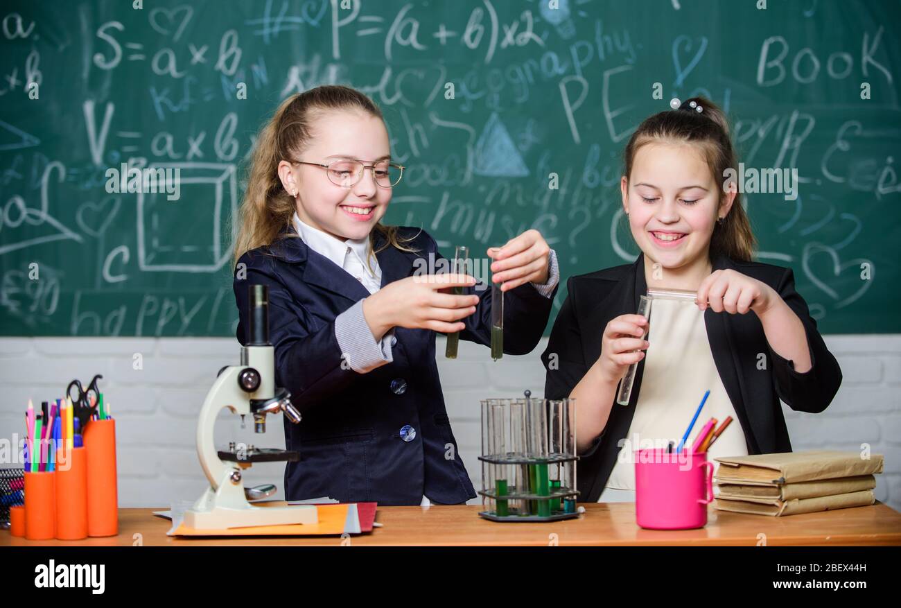 Little girls scientist work with microscope. Little girls in school lab ...