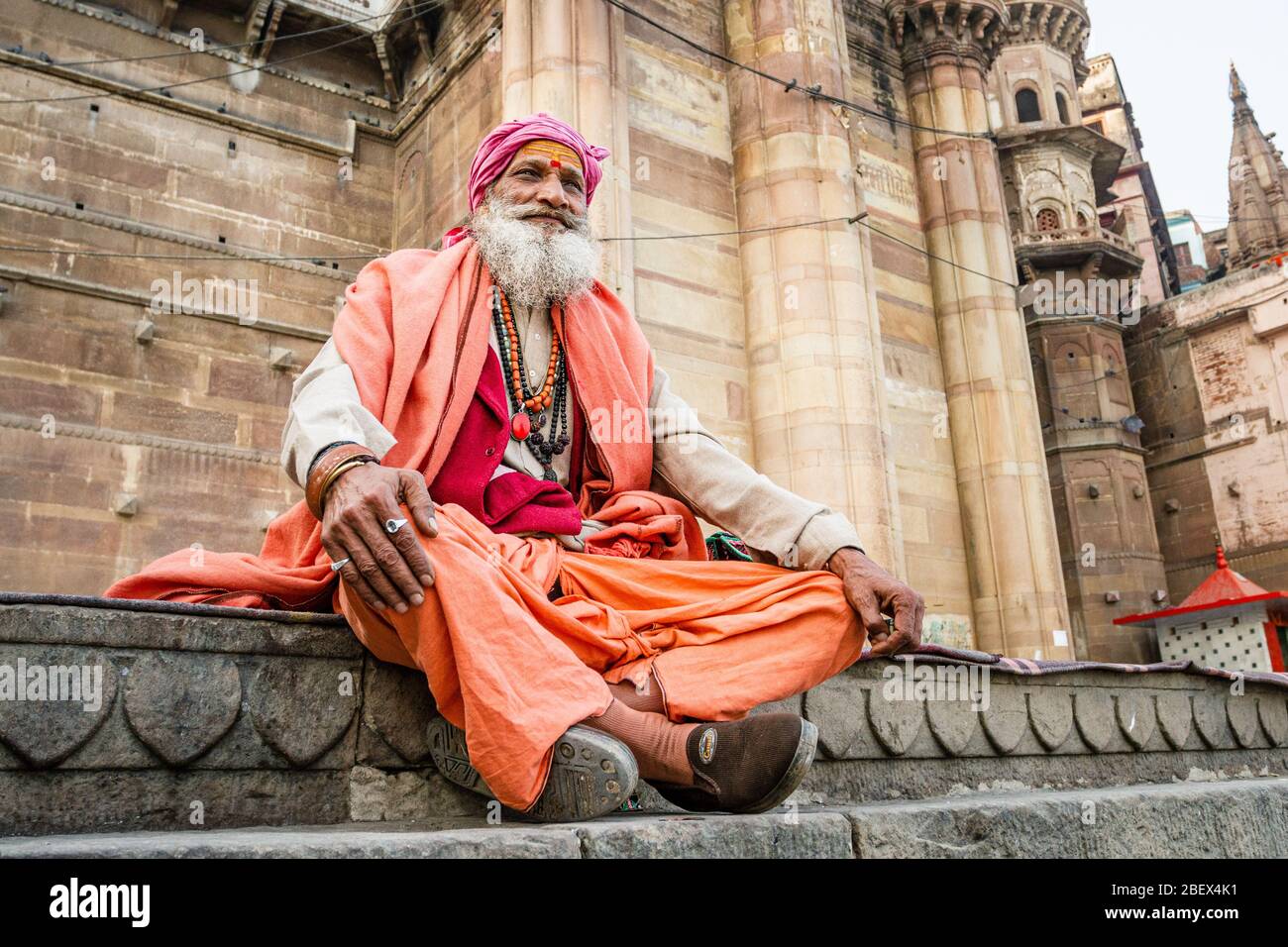 Sadhu baba sitting on the riverbank ghats of the Ganga River, Varanasi ...
