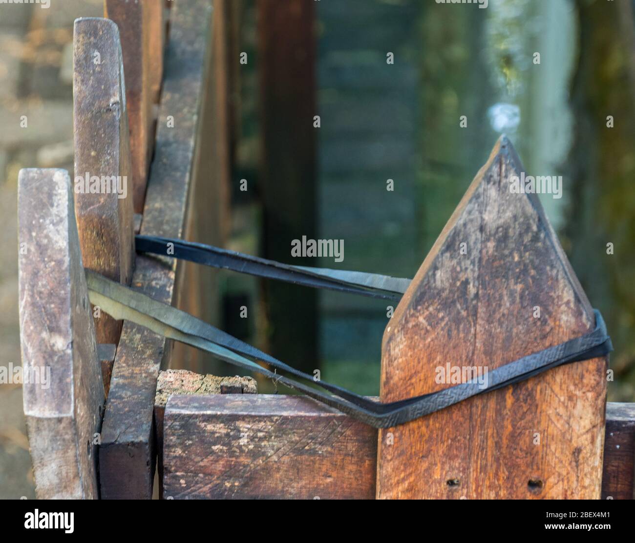 A black rubber band tied around a gate in a wooden fence image in ...